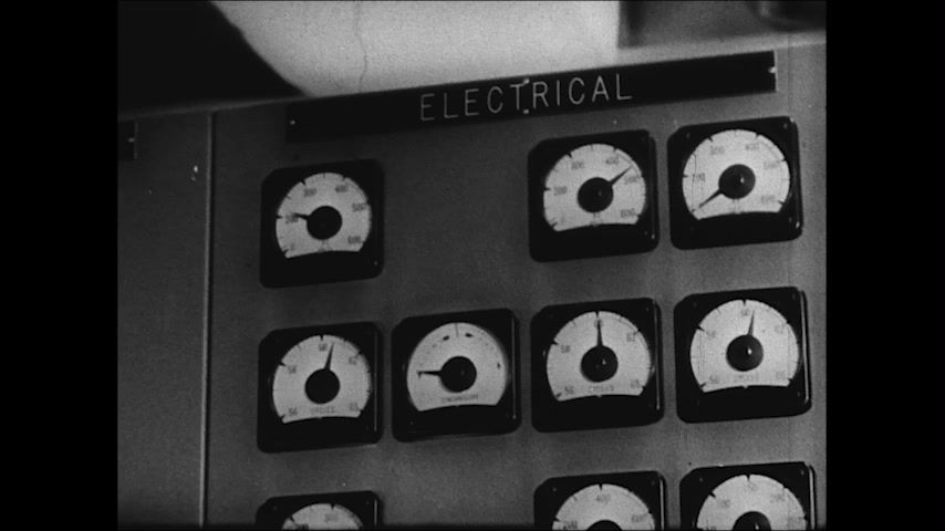 1950s: Control room of nuclear reactor. Gauges marked “ELECTRICAL” spin ...