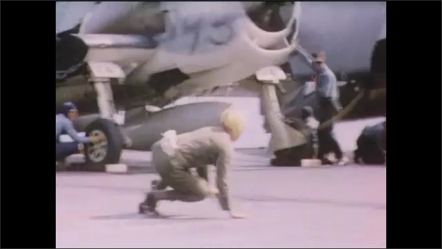 1940s: Sailors running on aircraft carrier deck. Planes taking off from ...