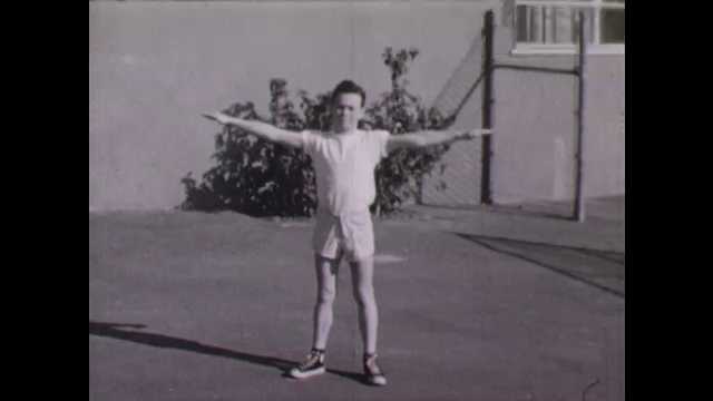 1950s: Young man performs exercises. – Archival Footage