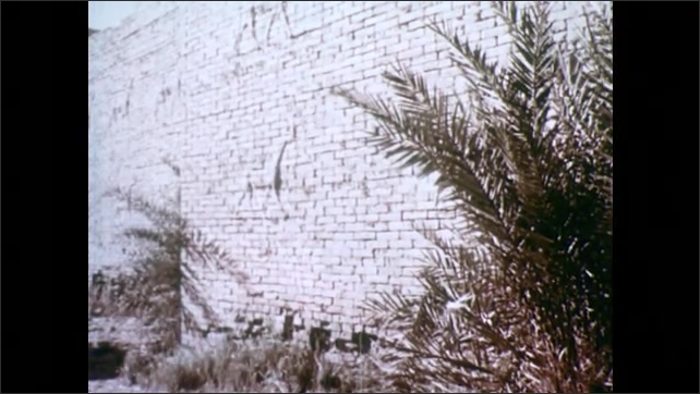 1950s: Sumerian village, Babylon, tall brick walls with embossed animal ...