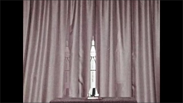 1960s: A model of Saturn I rocket profile on a stand. Two models of ...
