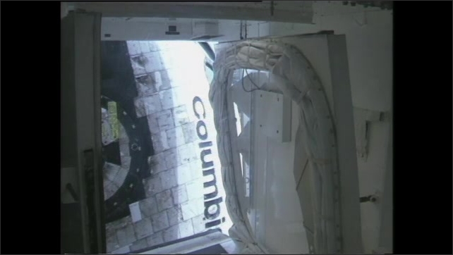 2000s: People help secure astronauts into seats onboard Space Shuttle ...