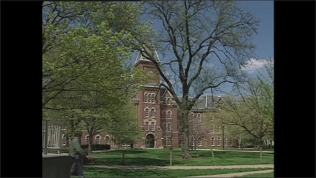2000s: People walking on campus with buildings. Building on campus ...