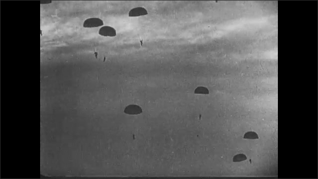 1940s: Airplanes overhead with paratroopers and parachutes below ...