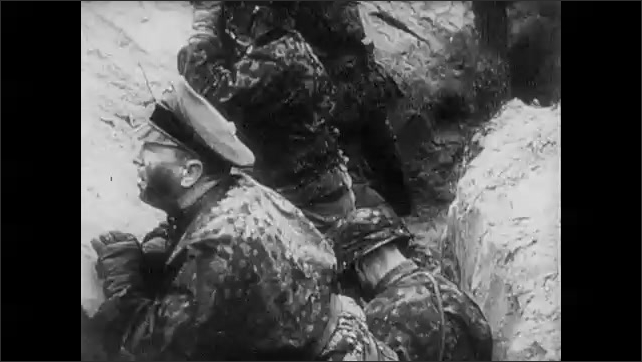 1940s: Soldier hide in tall grass, shoot bazooka. Explosion next to ...