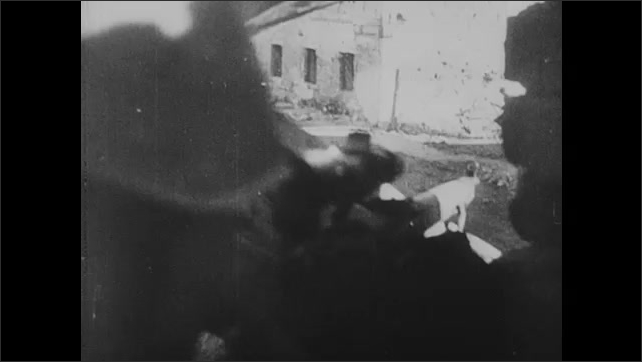 1940s: Nazi soldiers run and fall in street. Sniper shoots soldier ...