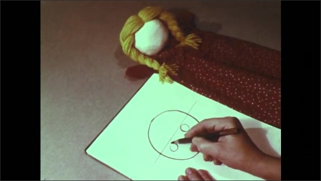 1950s: Person uses pencil to draw face on pad of paper with hand puppet ...