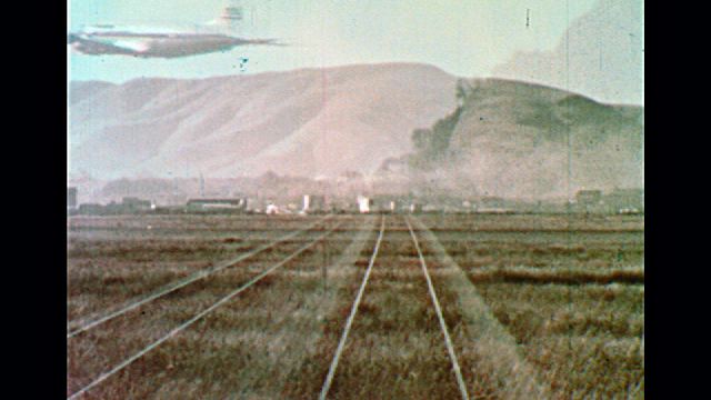 1950s: UNITED STATES: view of railway and freight train from train ...
