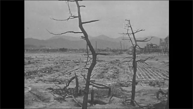 JAPAN 1940s: Rubble of ruined, bombed out city (Hiroshima). Two dead ...