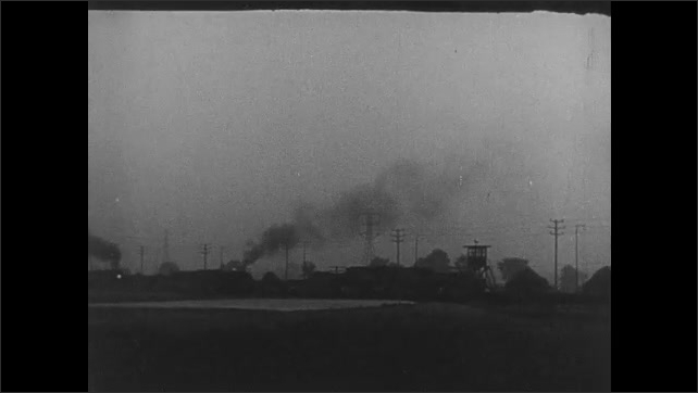 1940s: Tanks are transported on trailers. Train moves across track ...