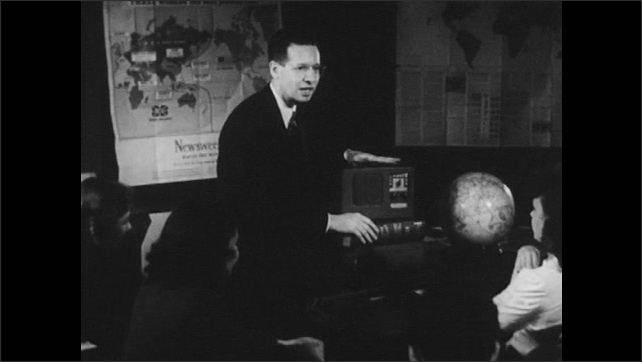 1950s: Male teacher lectures to a high school classroom of students ...
