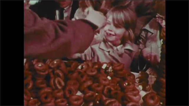 1960s: People bag up donuts. Boy grabs handfuls of donuts. People look ...
