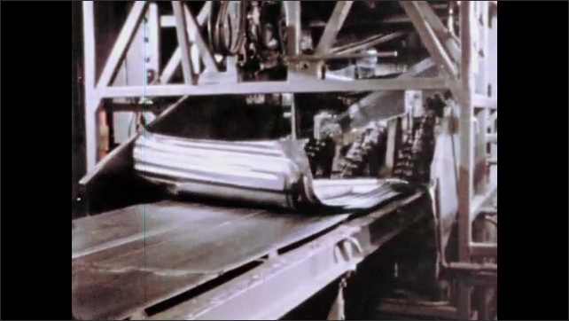 1960s: UNITED STATES: man feeds metal into machine. Metal comes out of ...