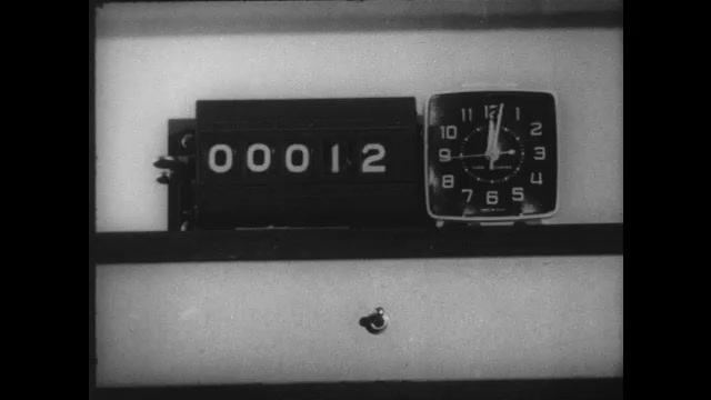 1960s: UNITED STATES: numbers on counter by clock timer – Archival Footage