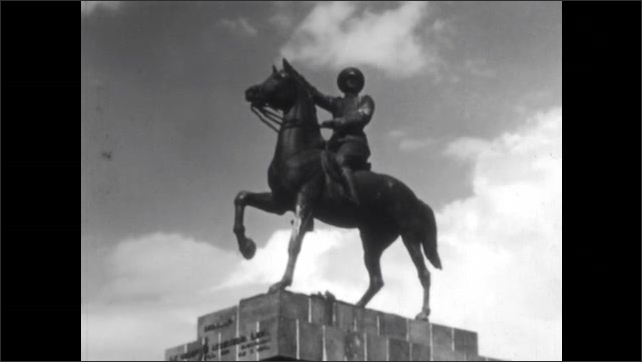 1960s: TURKEY: EUROPE: view across to settlement. Statue of man on ...