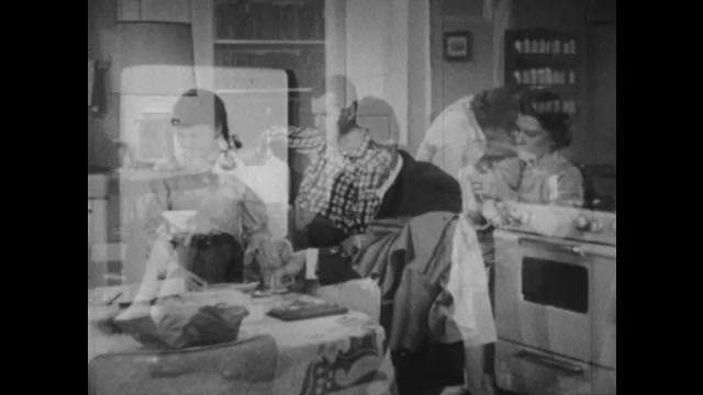 1950s: Father and daughter sit with homework on couch, mother sews ...