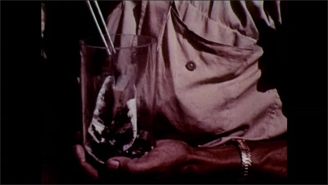 1960s: UNITED STATES: South American Armadillo. Man handles armadillo ...