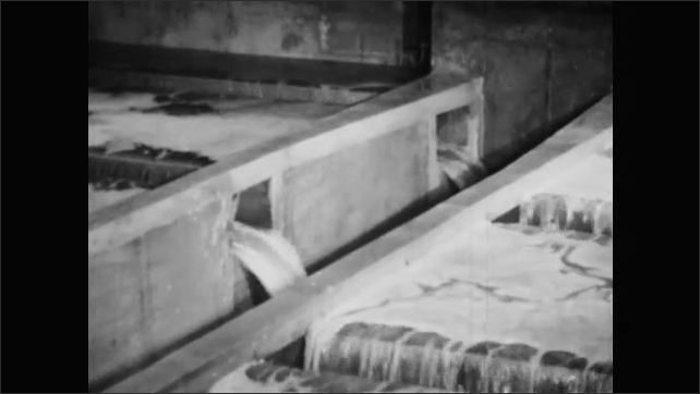 1950s: Water flows through water tank. Water pours from pipe into lake ...