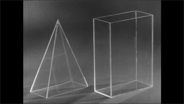 1950s: hand pours dirt from clear pyramid model into plexiglass cuboid ...
