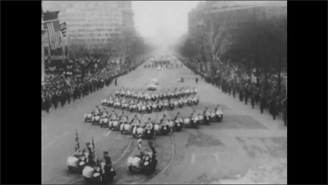 1950s: Crowds hold signs and placards in arena. Motorcycles drive in ...