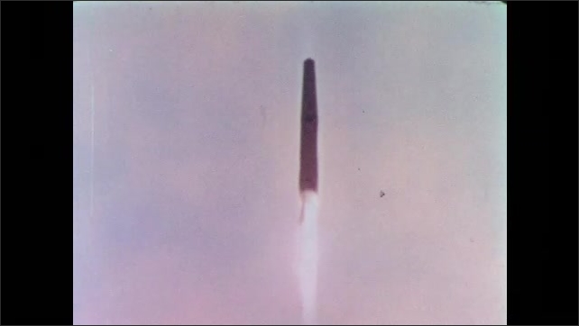 1960s: Smoke and fire plume as rocket launches from pad. Fire belches ...