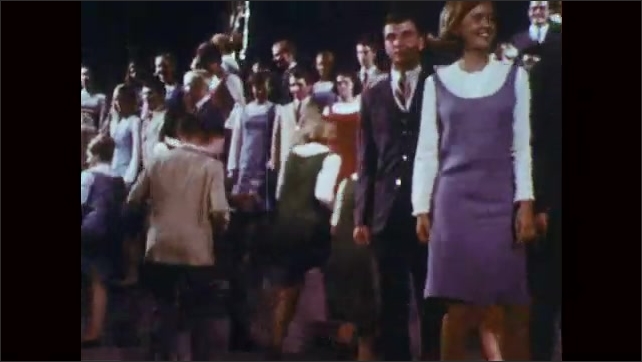 1960s: People run up steps. People run past man, line up on steps ...