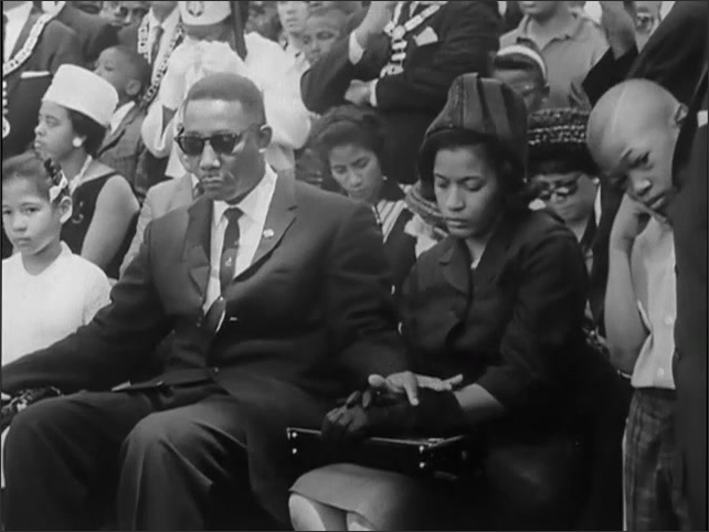 1960s: Mourners at the Medgar Evers funeral at Arlington National Cemetery. Man speaks before ...