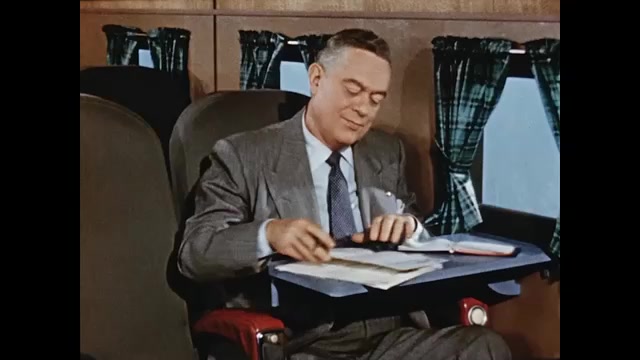 1950s: Pilot walks from cockpit through passenger area of plane. Pilot ...